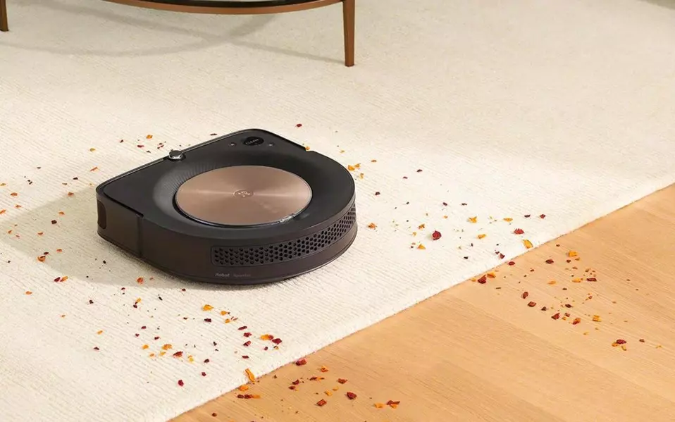 iRobot Roomba s9+ vacuuming carpet.